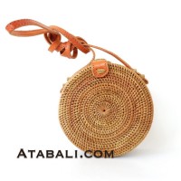 ata bucket bag with long leather strap and rattan cross clip